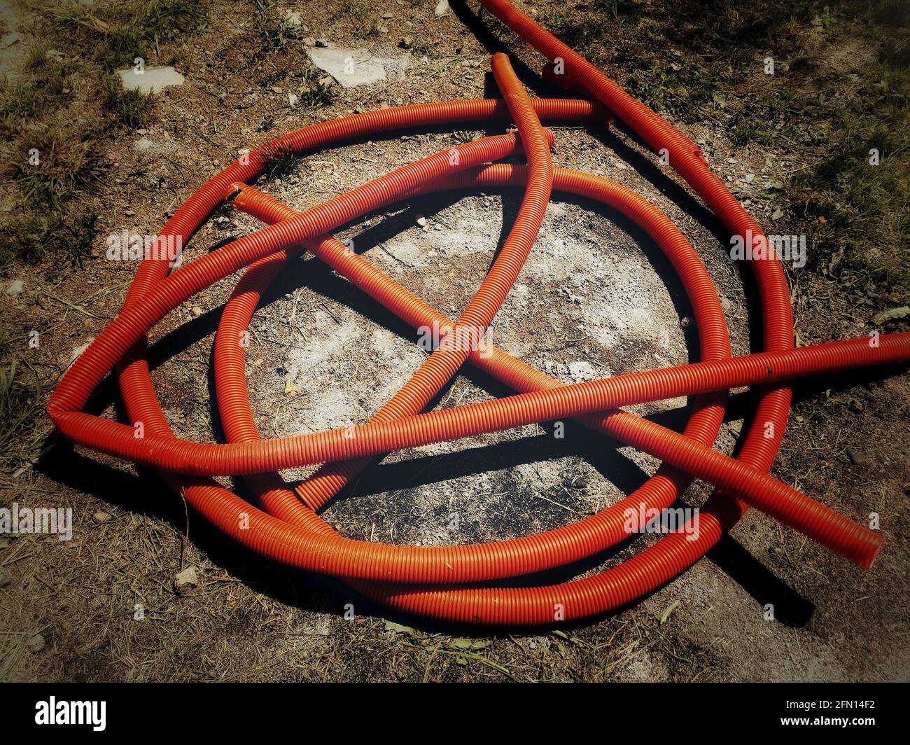 Top view of a red hose on the ground Stock Photo - Alamy