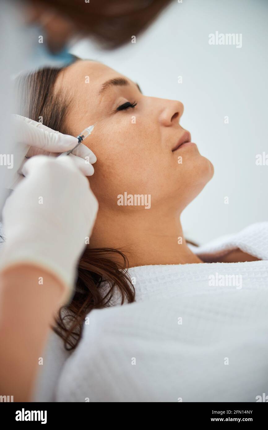 Female getting a beauty injection in a wellness center Stock Photo - Alamy