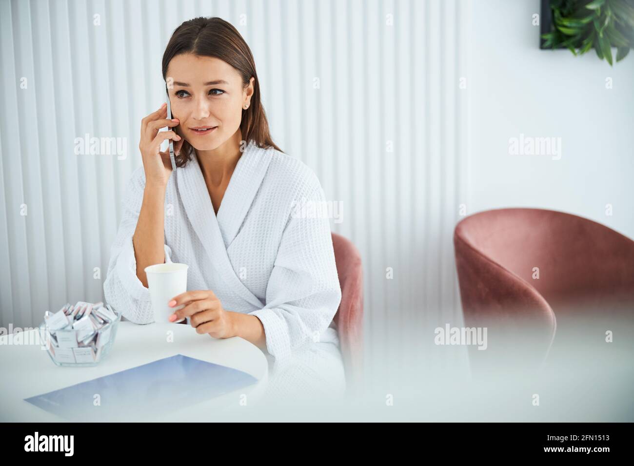 Spa client calling on her mobile phone Stock Photo - Alamy
