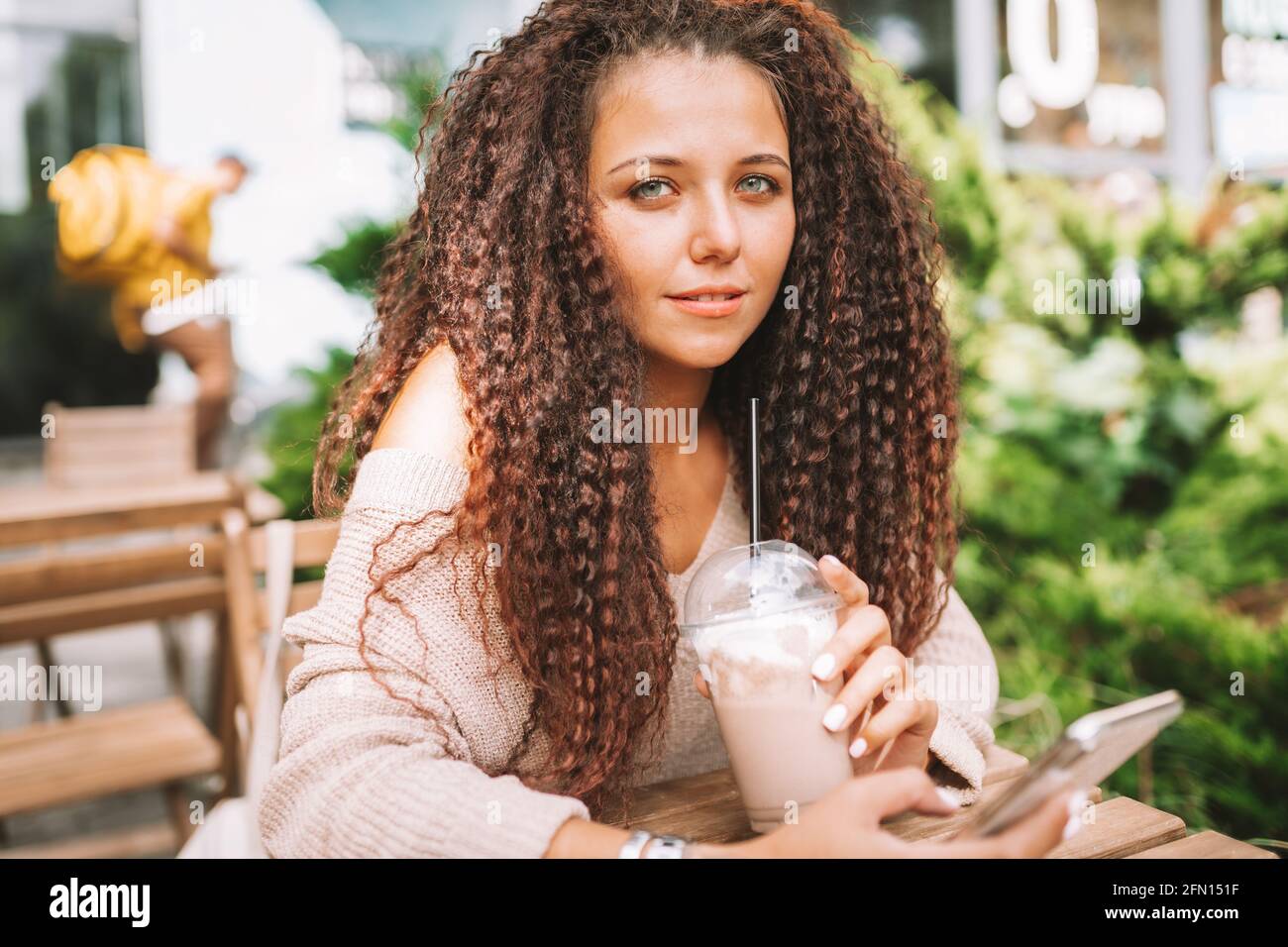 Young woman addicted to technology. Female use smartphone sitting at ...