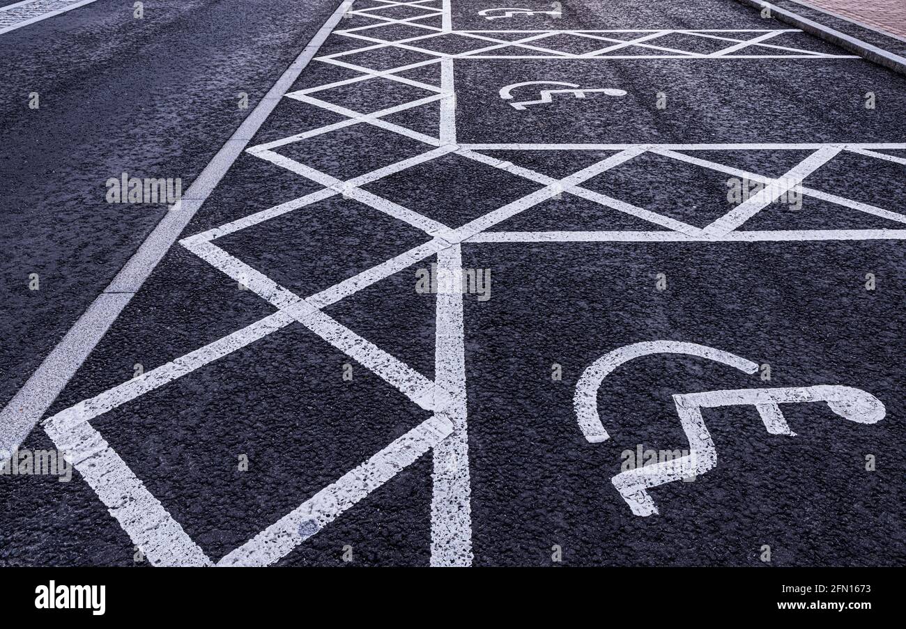 Disabled parking spaces painted on a tarmac road Stock Photo - Alamy