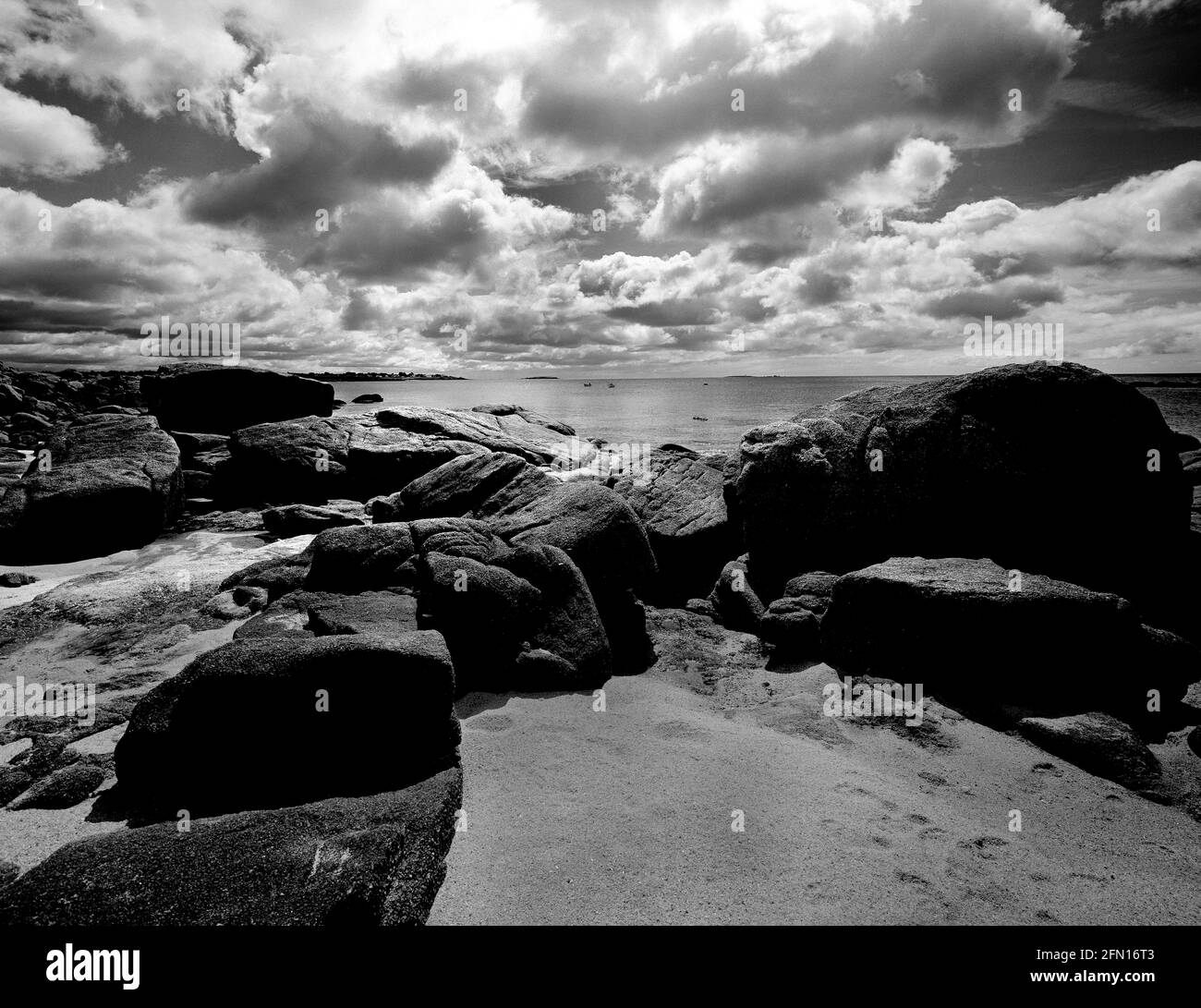Black and White rocks on beach with sea & sand, Brittany, France clouds ...