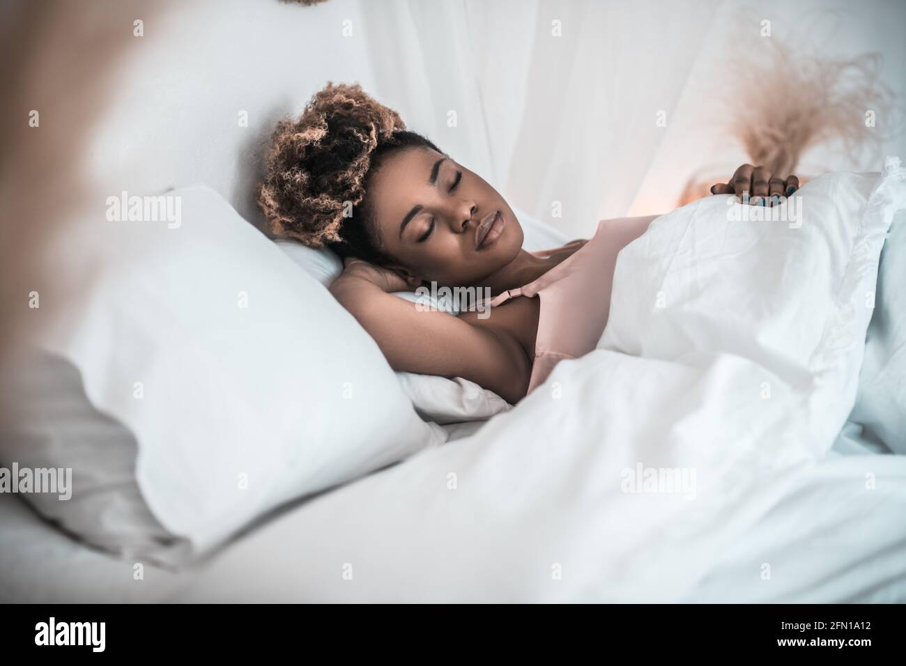 African american woman sleeping soundly in bed Stock Photo - Alamy