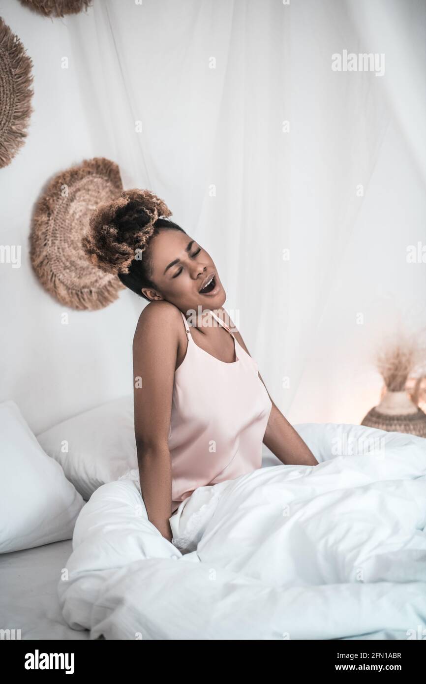 Yawning waking woman in morning in bed Stock Photo - Alamy