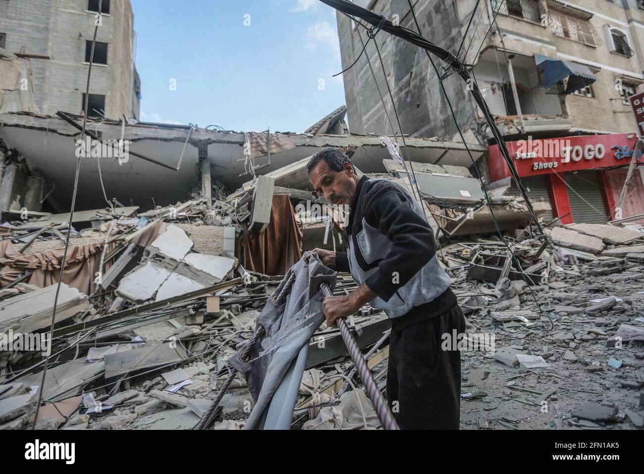 Gaza City, Palestinian Territories. 13th May, 2021. A man inspects the ...