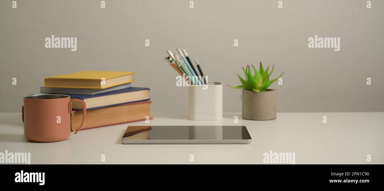 Close up view of study table with digital tablet, books, stationery ...