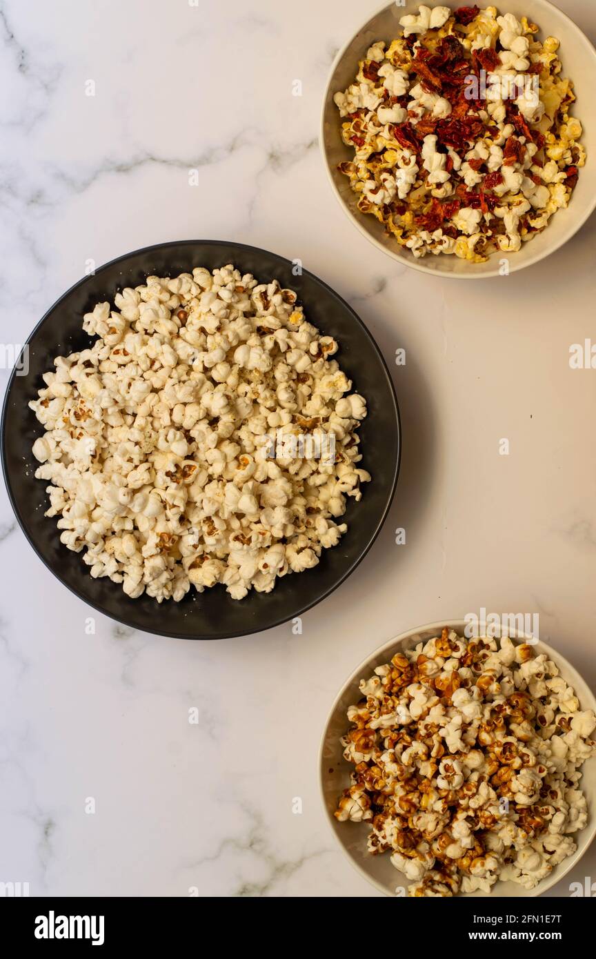 A bowl full of pop corn on a white background Stock Photo - Alamy