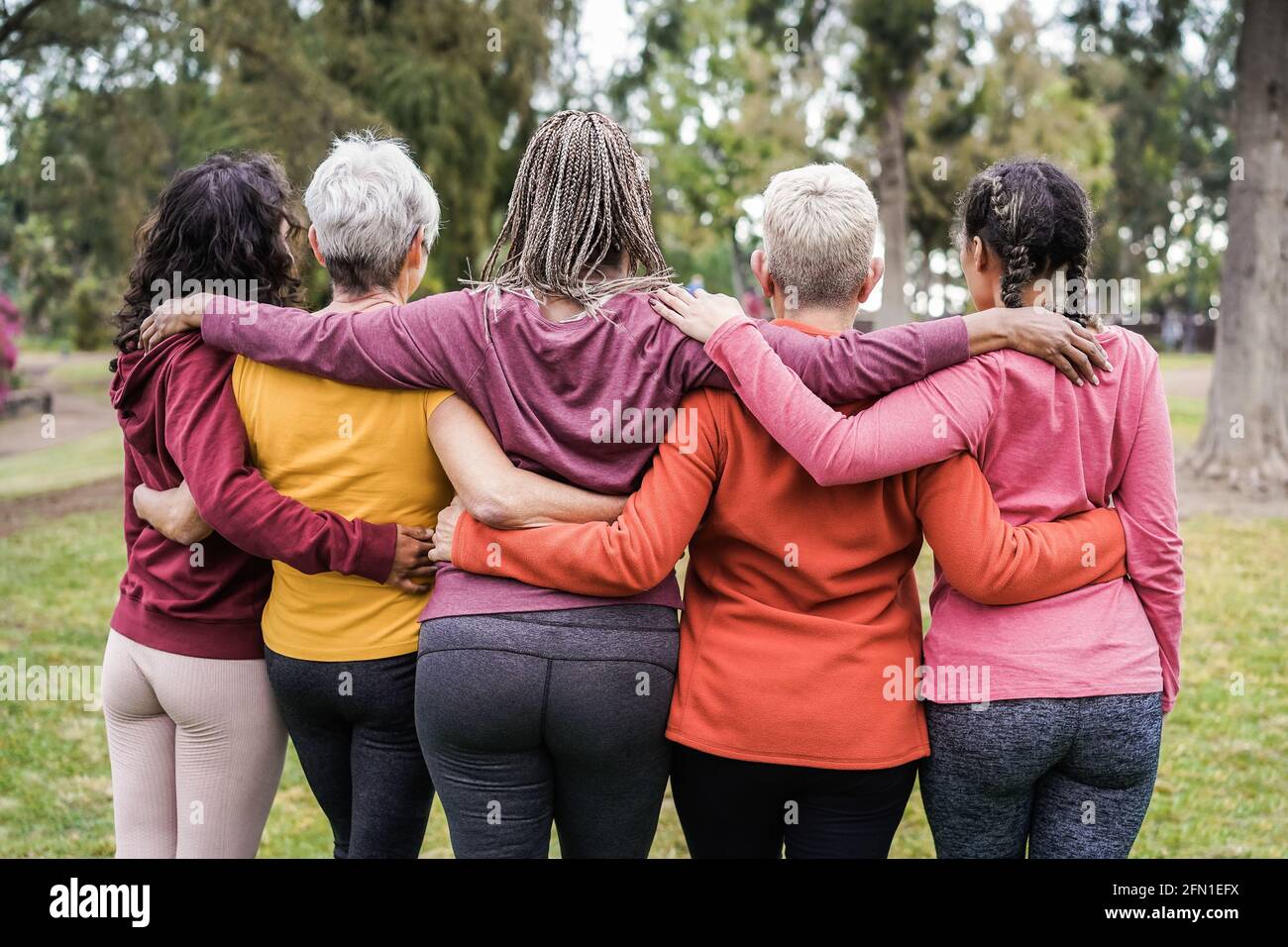 Back view of multi generational women having fun together outdoors in ...