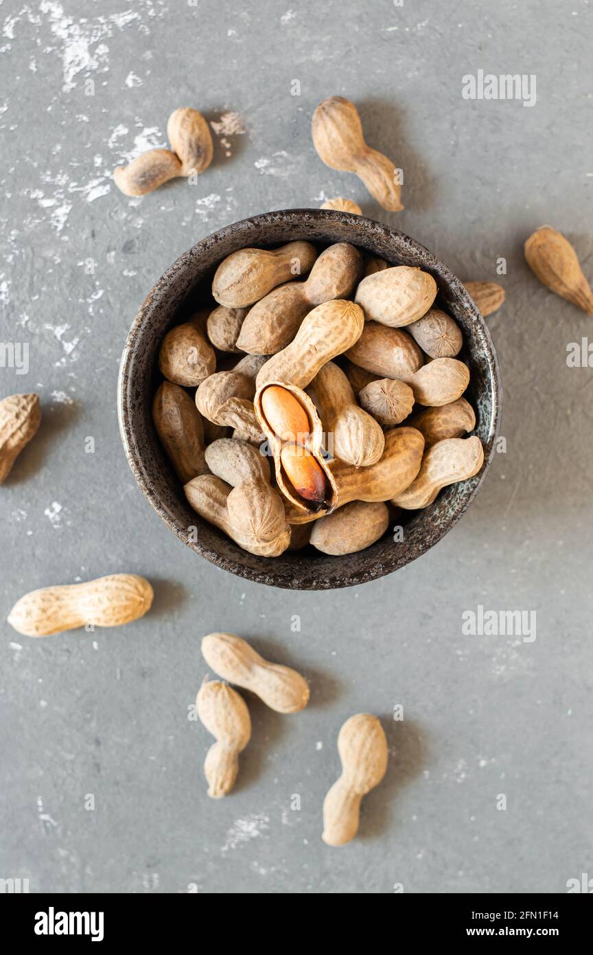 Roasted peanuts, cracked. On a grey background Stock Photo - Alamy