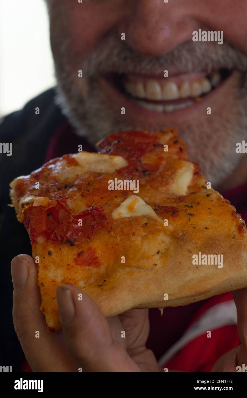 Old man eating pizza hi-res stock photography and images - Alamy