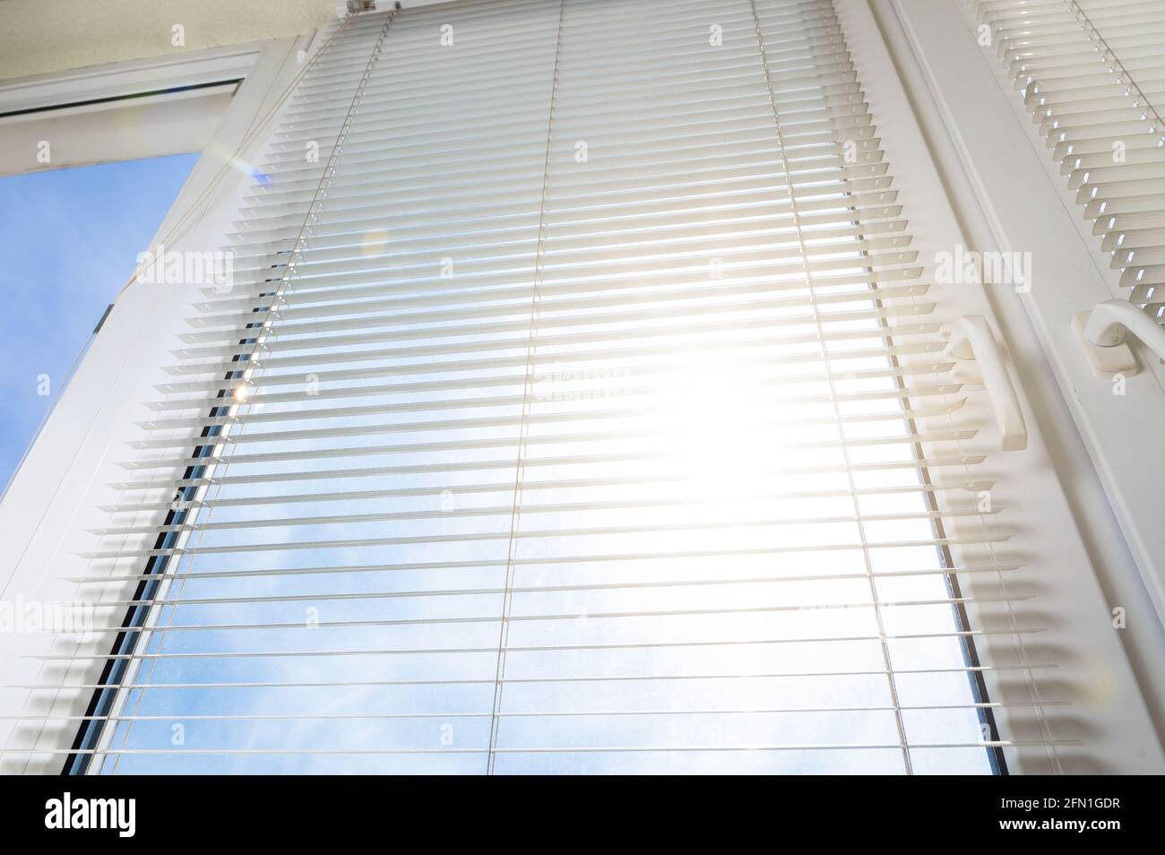 Sun shining through window blinds. The bright sun breaks through the ...