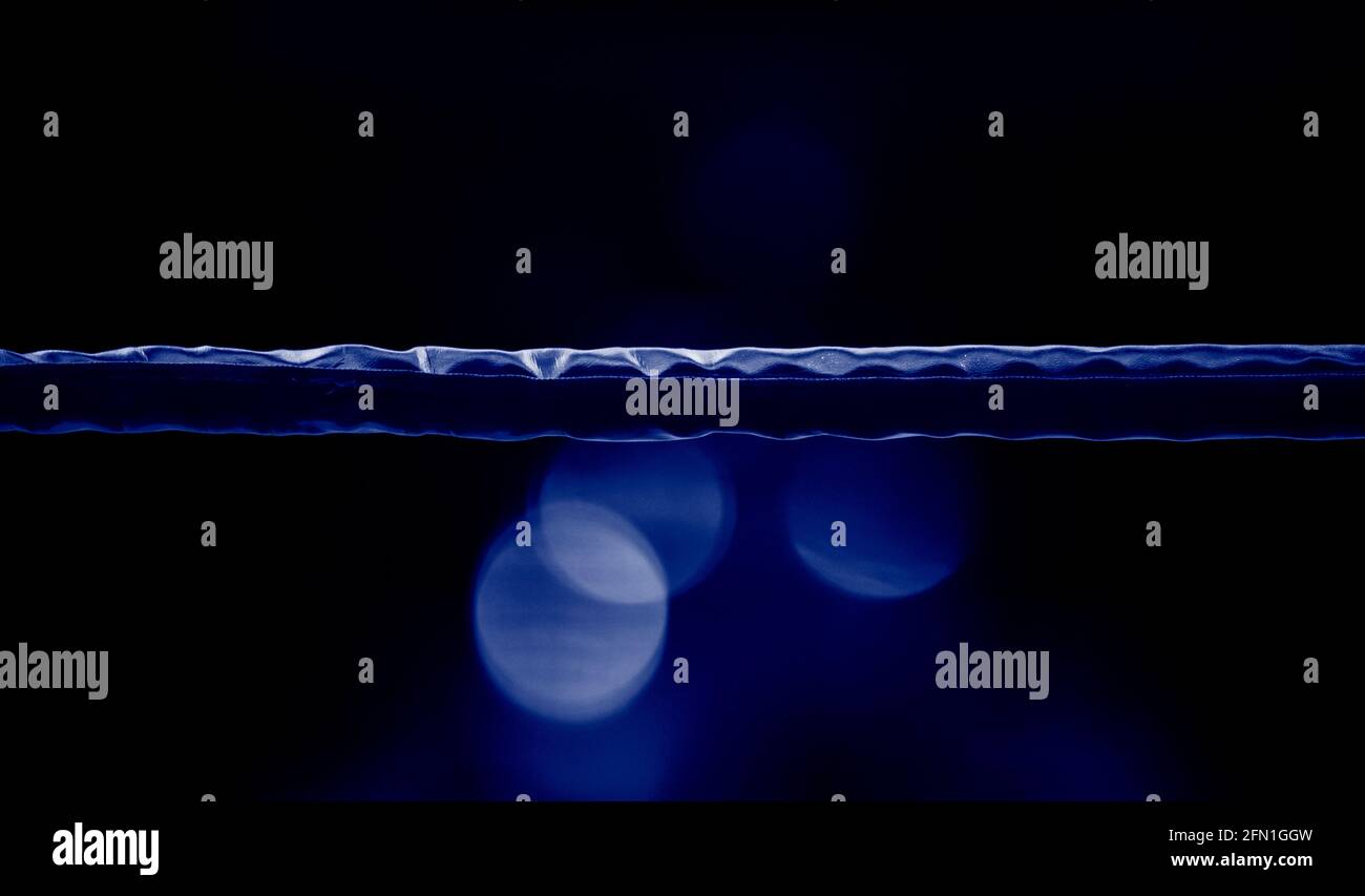 Boxing ring ropes with a blur spotlight. Blue color filter Stock Photo ...