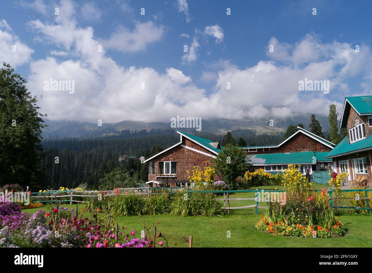 Scenic view of a modern house surrounded by flowers and nature in ...