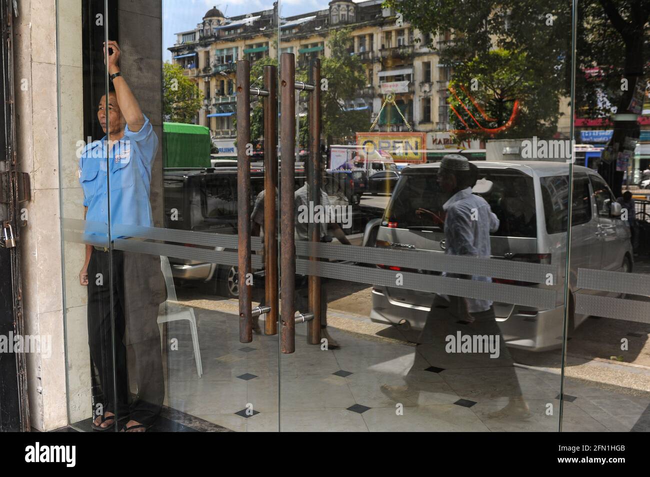 04.10.2013, Yangon, Myanmar, Asia - Security guard stands behind a ...