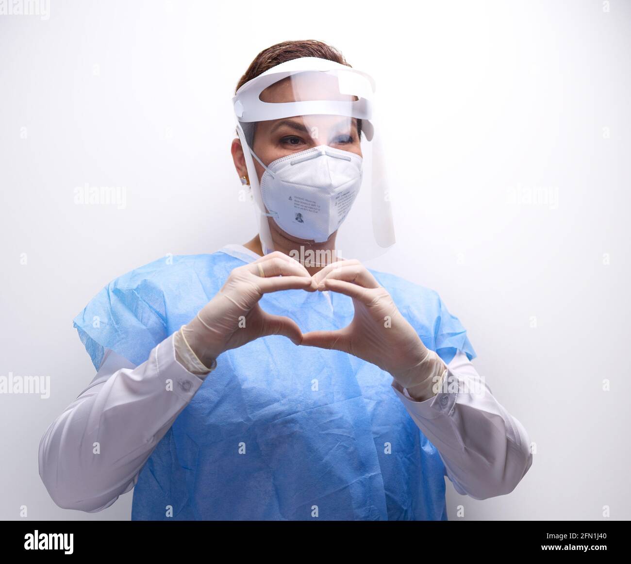 Doctor making heart gesture hi-res stock photography and images - Alamy