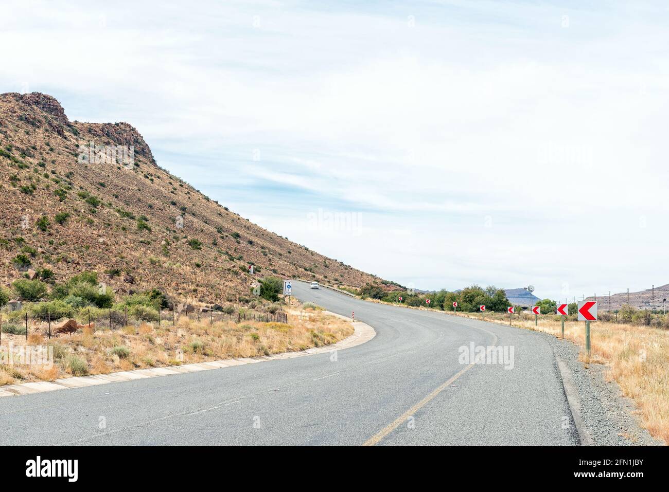 National road N1 at Three Sisters in the Northern Cape Karoo. A vehicle ...