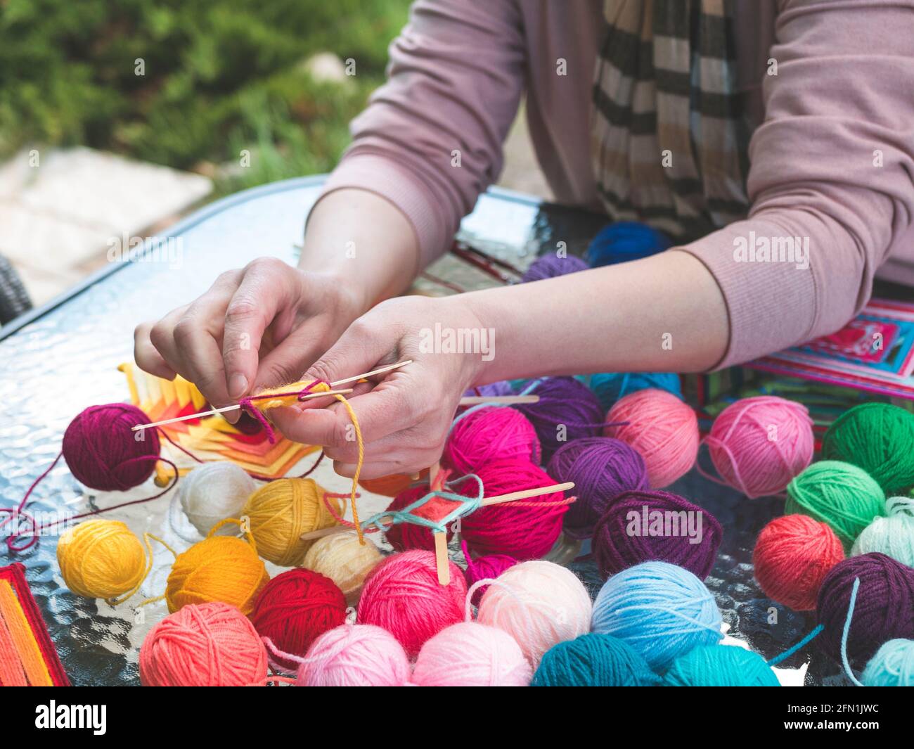 Making mandala from colored yarn and sticks. Mandala weaving. Concept ...