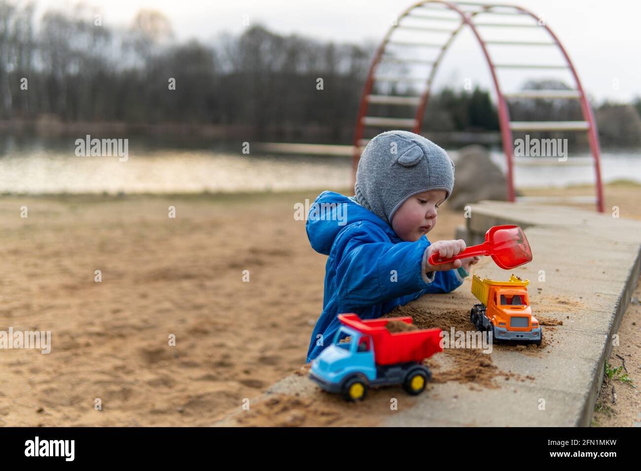the kid pours sand into the machine. space for text . high quality ...