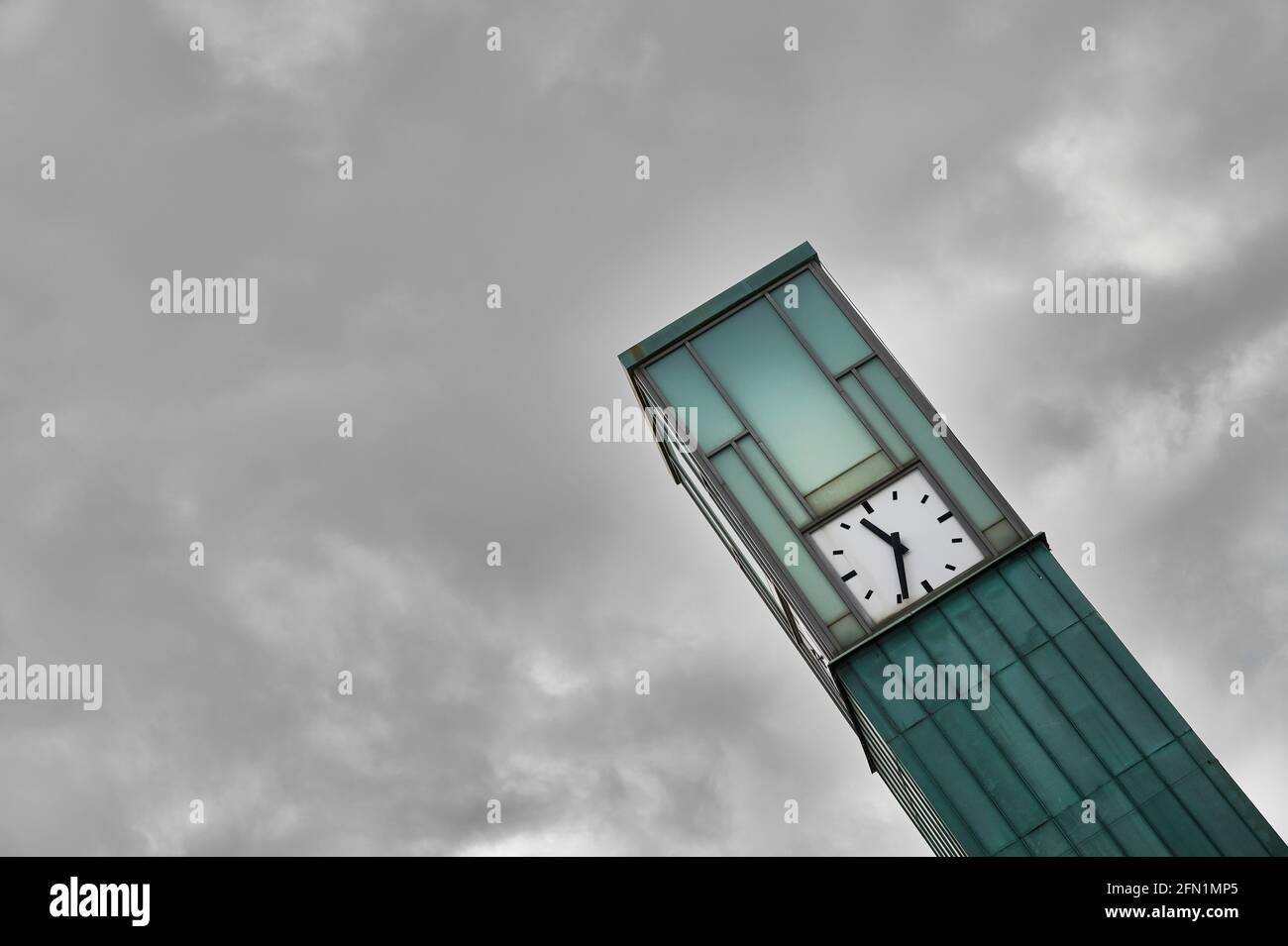 Modern tower clock over cloudy sky Stock Photo - Alamy