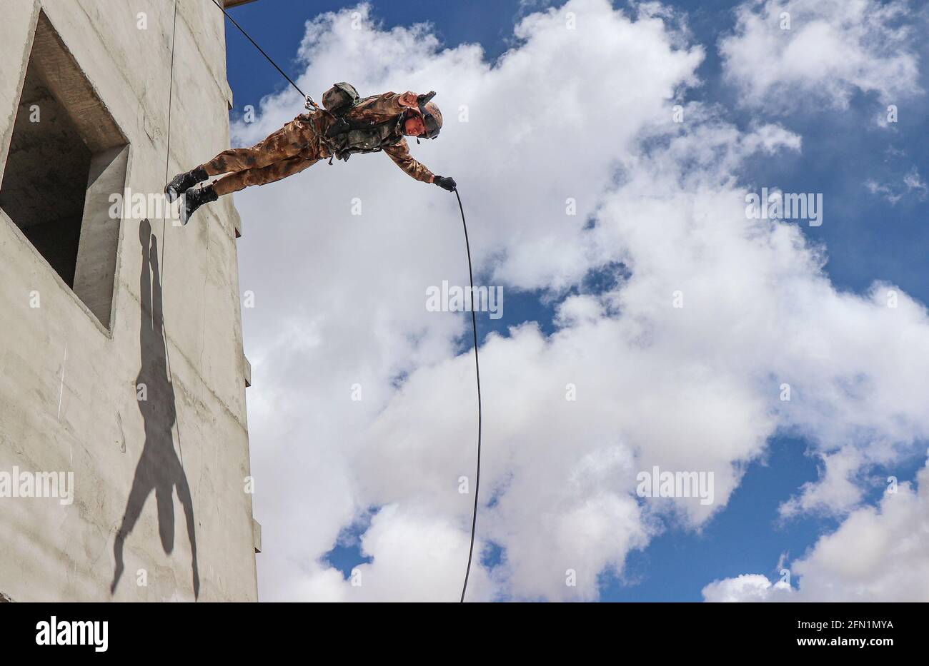 ALI, CHINA - MAY 13, 2021 - A soldier performs sliding down training in ...