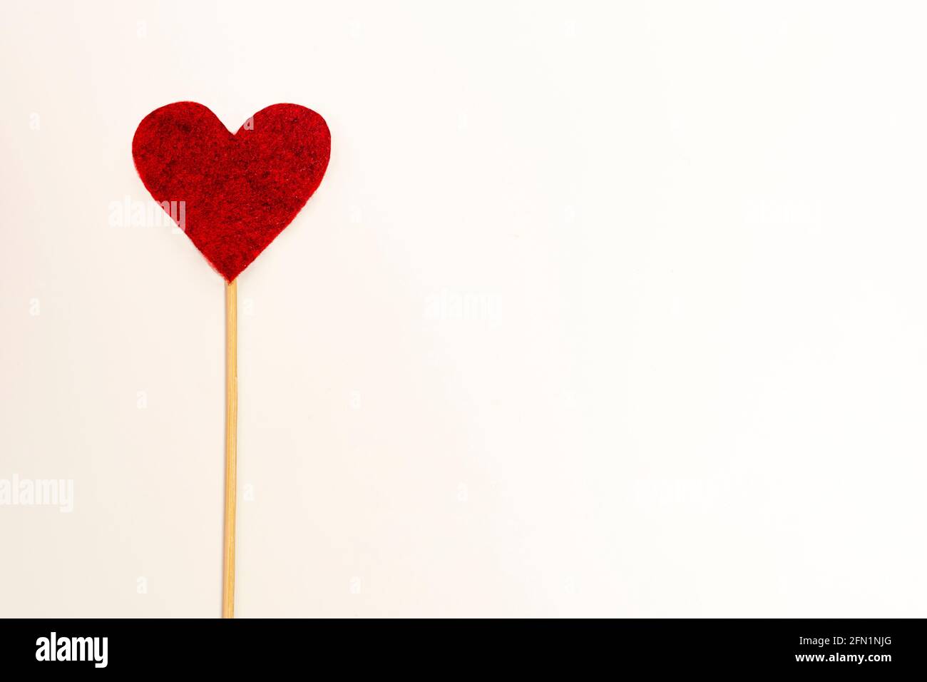 red heart on a stick on a white background. concept birthday and ...