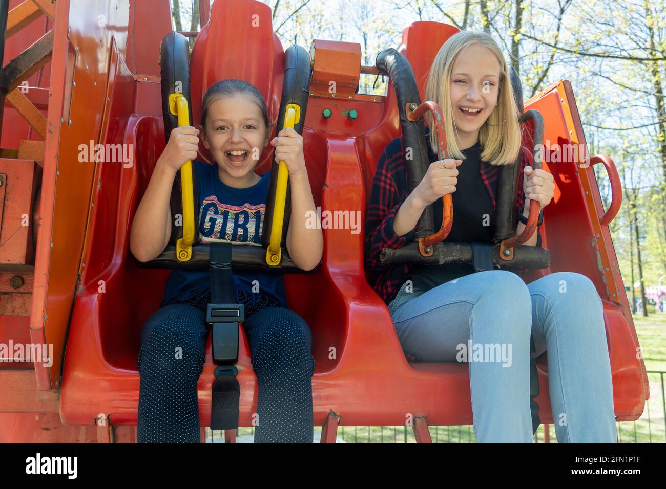 Two girls scream and laugh at the amusement park amusement park Stock ...
