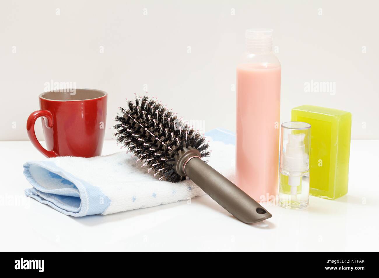 Bottle of shampoo, a towel, a comb and soap on the white background ...