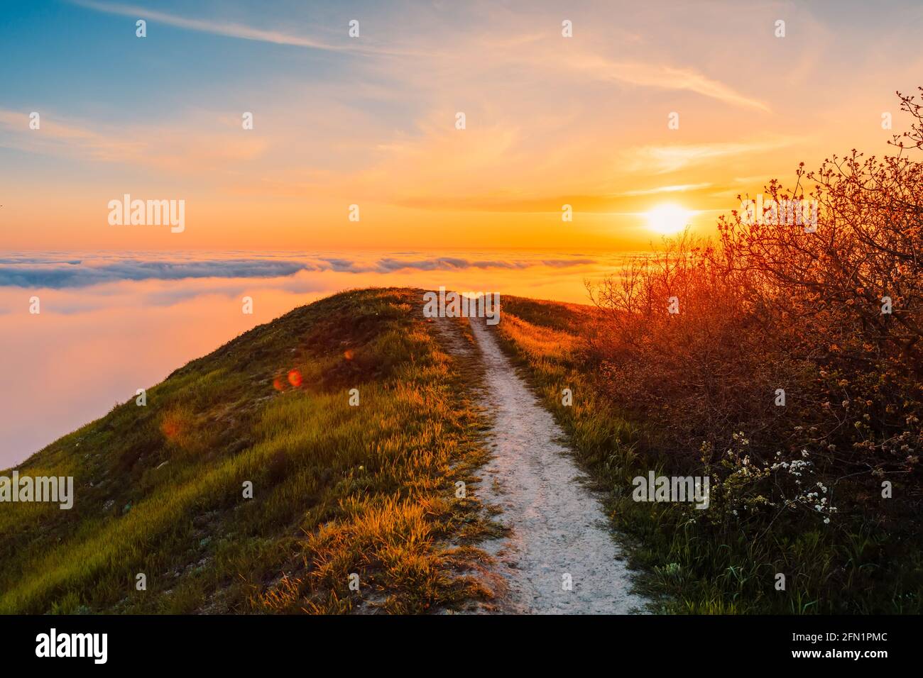 Bright sunset, clouds and mountains with trail Stock Photo - Alamy
