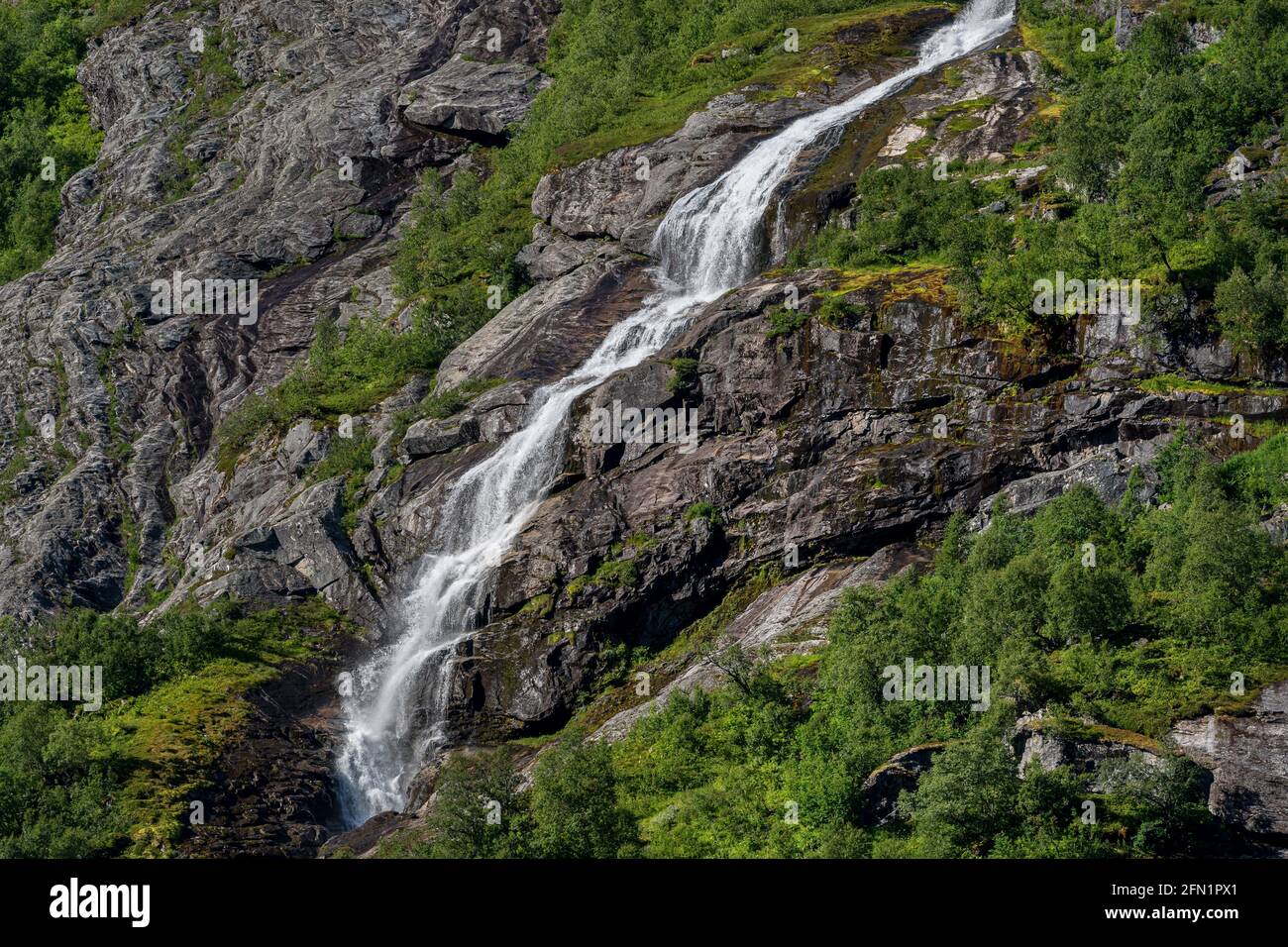 FLO, NORWAY - 2020 AUGUST 10. Snow is melting and make waterfall down ...