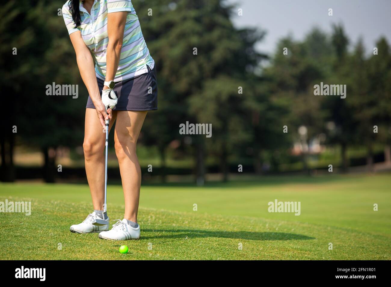 Female golfer putting ball in hole hi-res stock photography and images ...