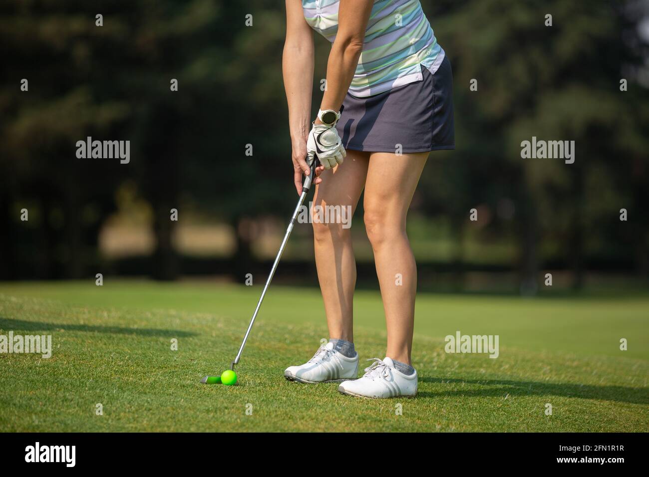 Female golfer putting ball in hole hi-res stock photography and images ...