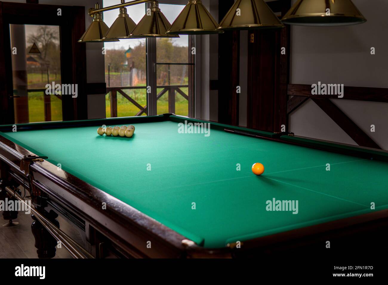 Russian billiard table with balls and cue sticks on a green background ...