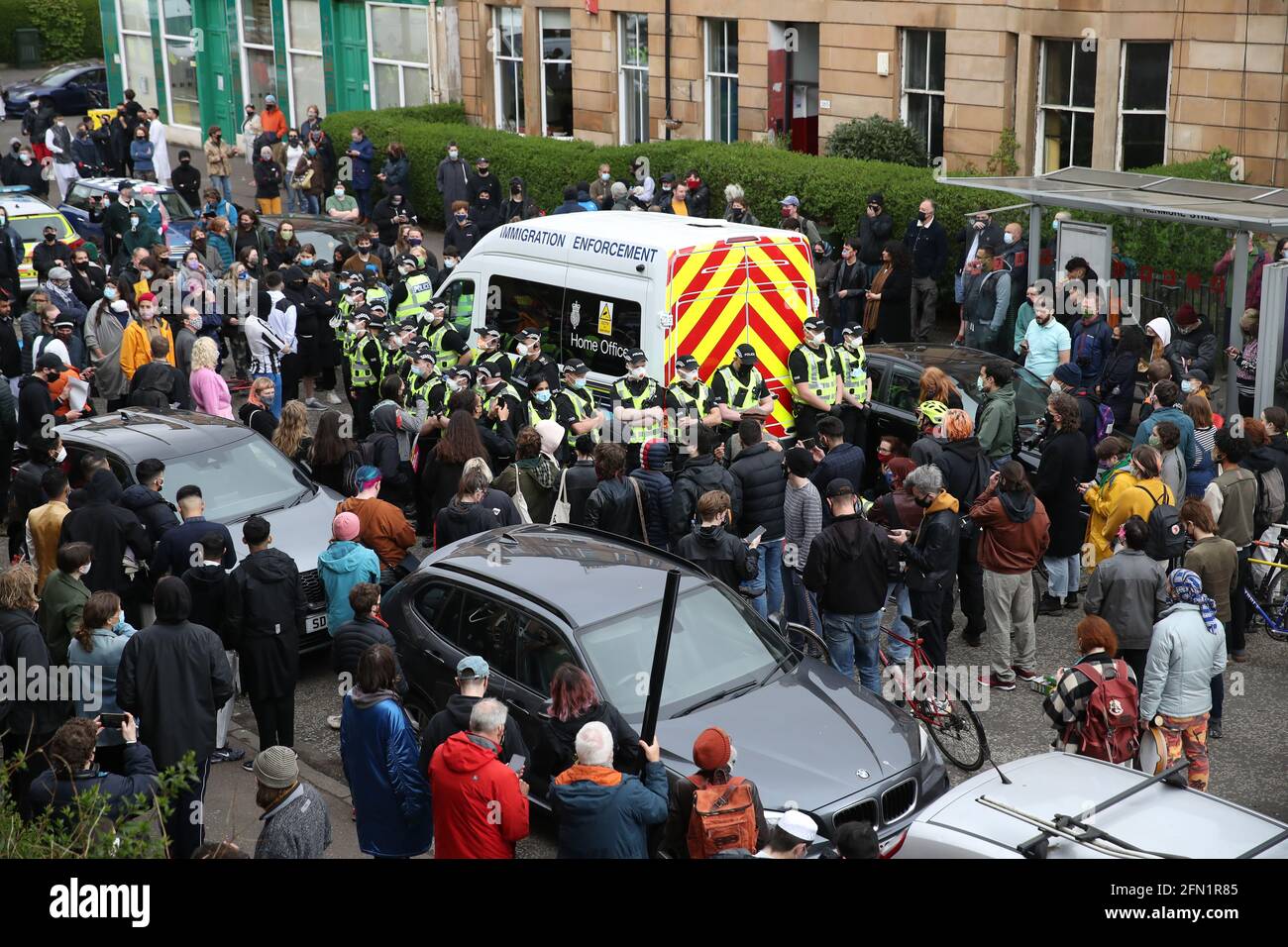 Police by an immigration van in Kenmure Street, Glasgow which is ...