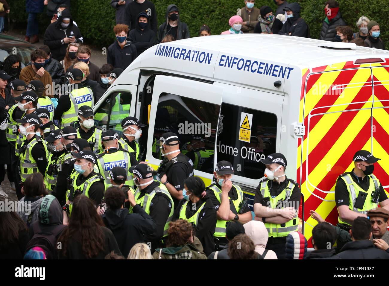 Police by an immigration van in Kenmure Street, Glasgow which is ...