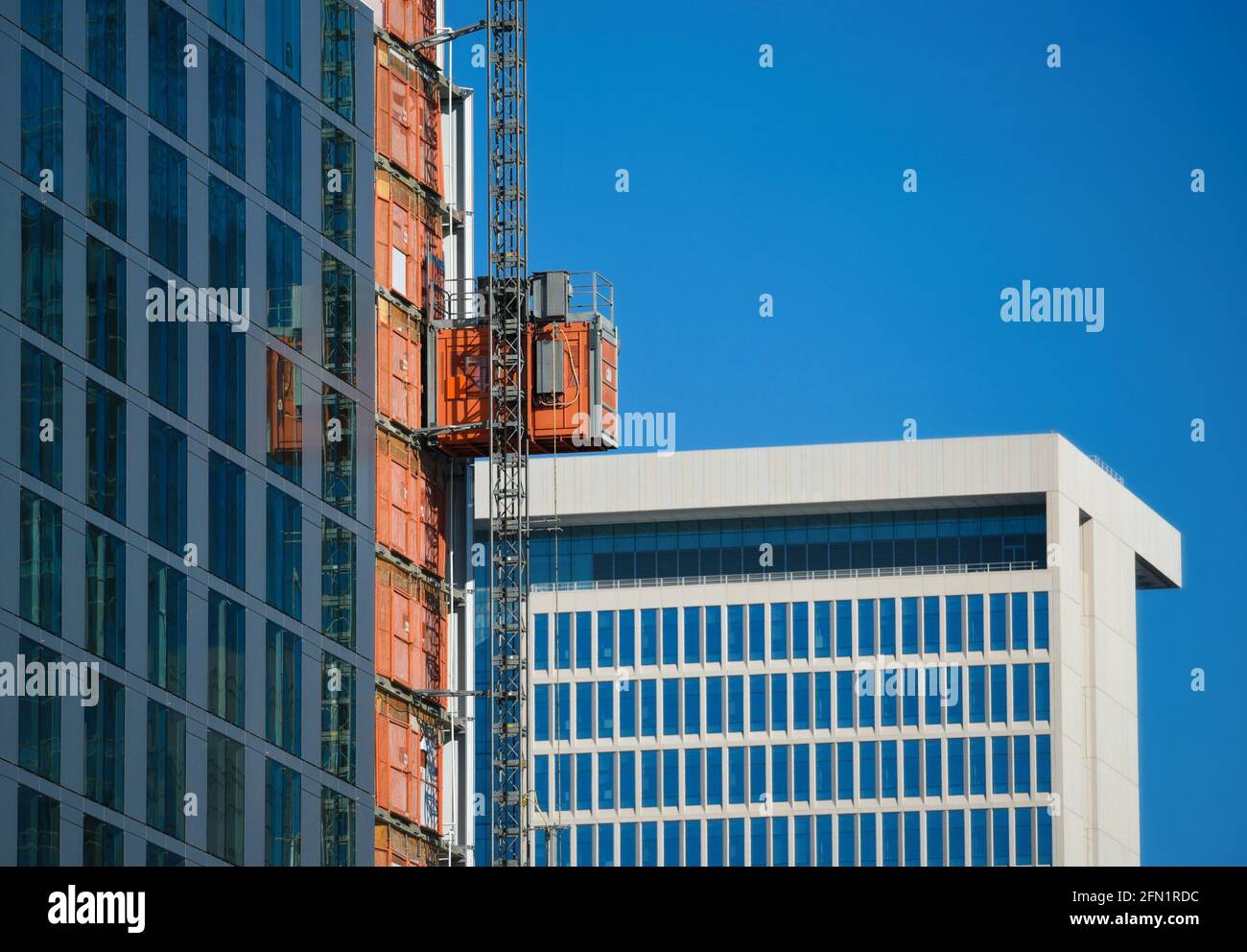 High-rise building with an orange construction hoist in downtown San ...
