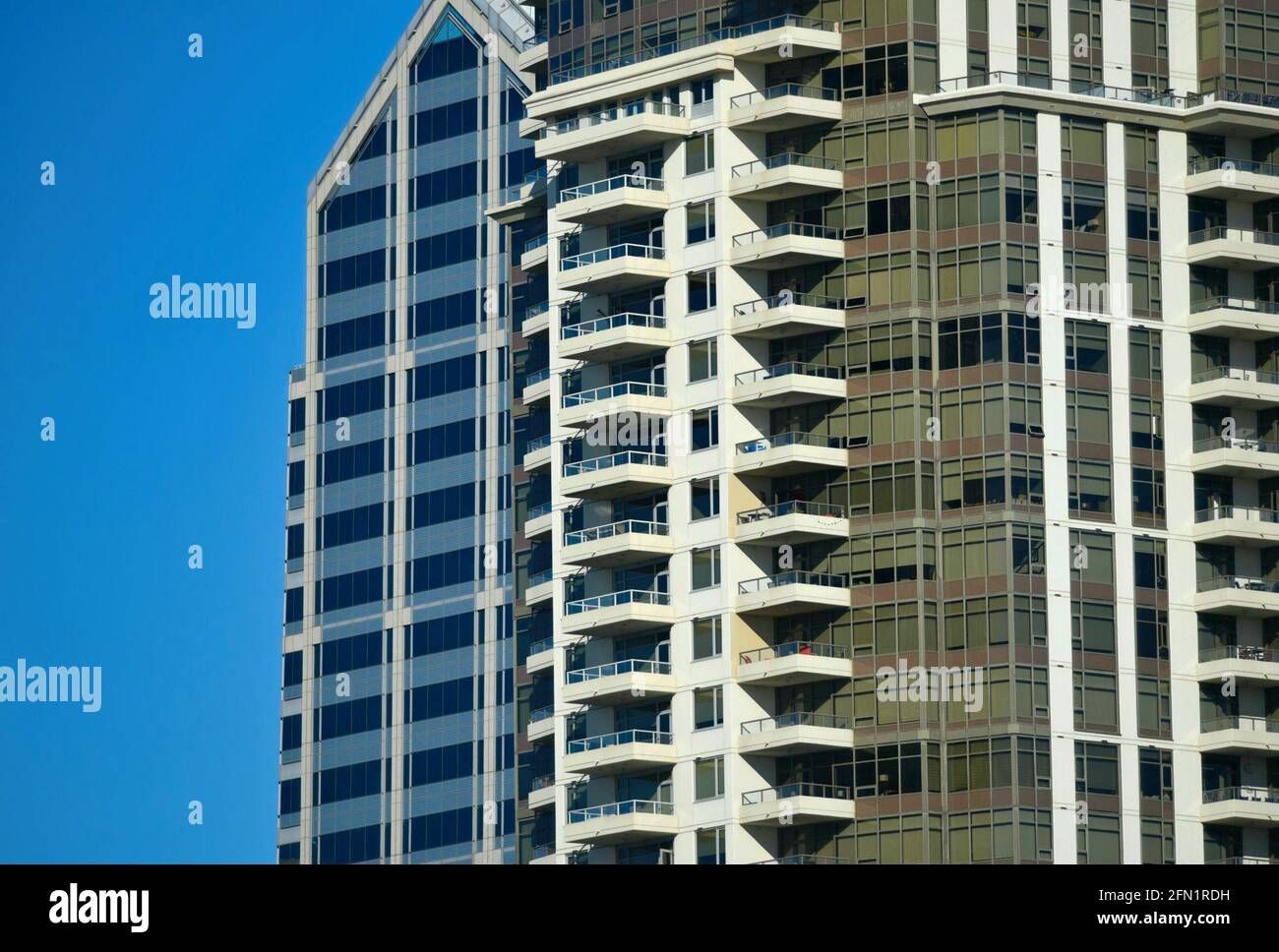 Residential condominiums complex facade with symmetrical white concrete ...