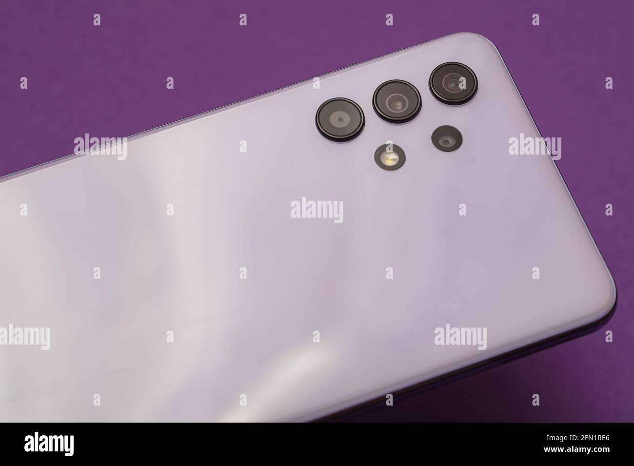 Violet smartphone on purple background for design purpose Stock Photo ...