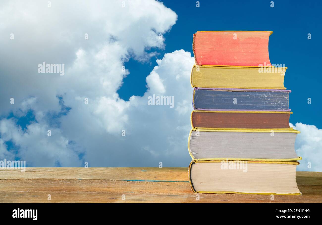 stack of books with beautiful clouds in the background free copy space ...