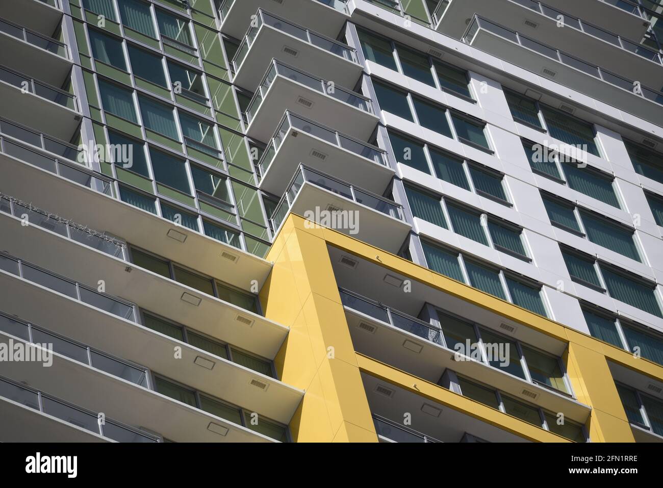 Residential high-rise condominiums complex facade with white and yellow ...