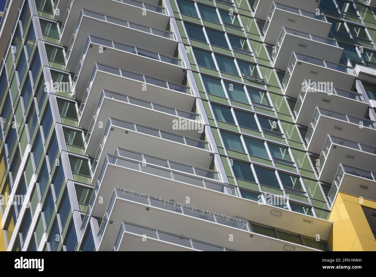 Residential condominiums complex facade with symmetrical white concrete ...