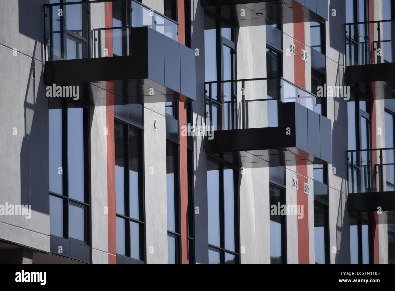 High-rise condominiums complex facade with a red, white and black ...
