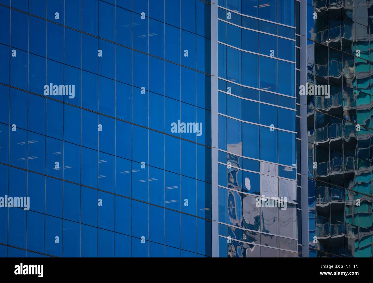 Corporate offices high-rise building with a blue glass and steel facade ...