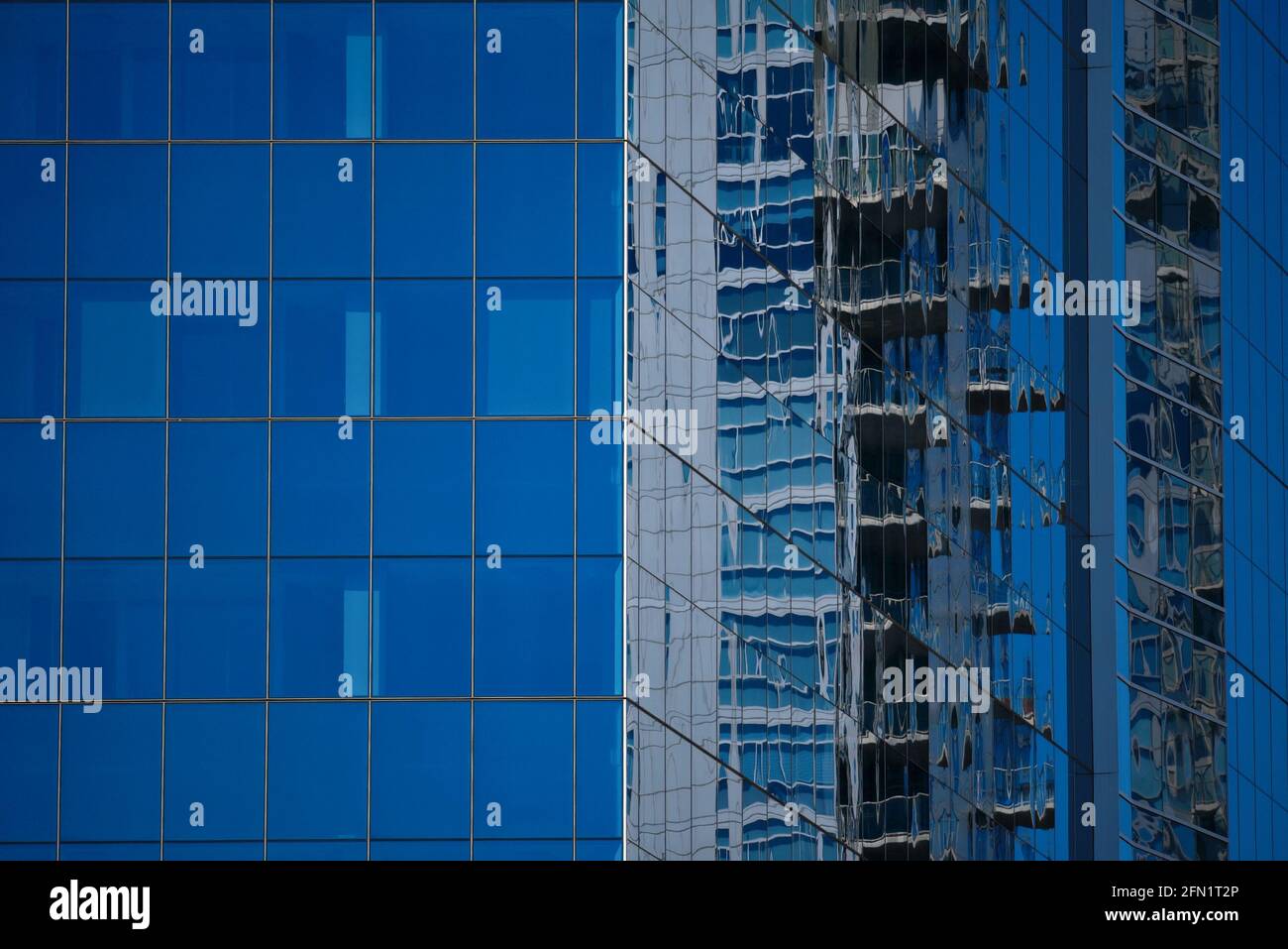 Corporate offices high-rise building with a blue glass and steel facade ...
