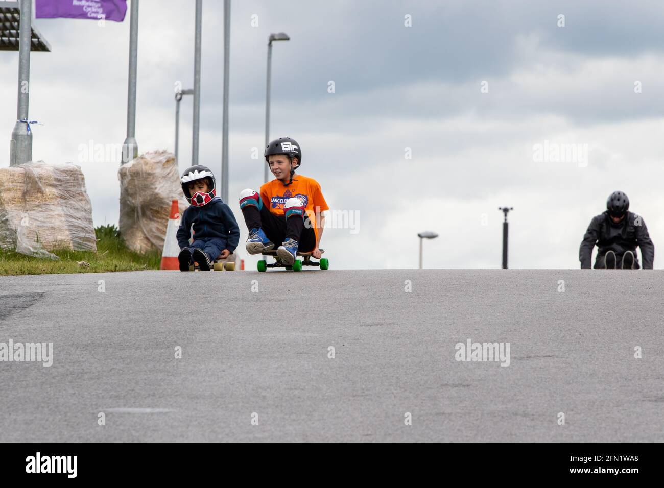 Two small boys having fun on a cycle road racing track Stock Photo - Alamy