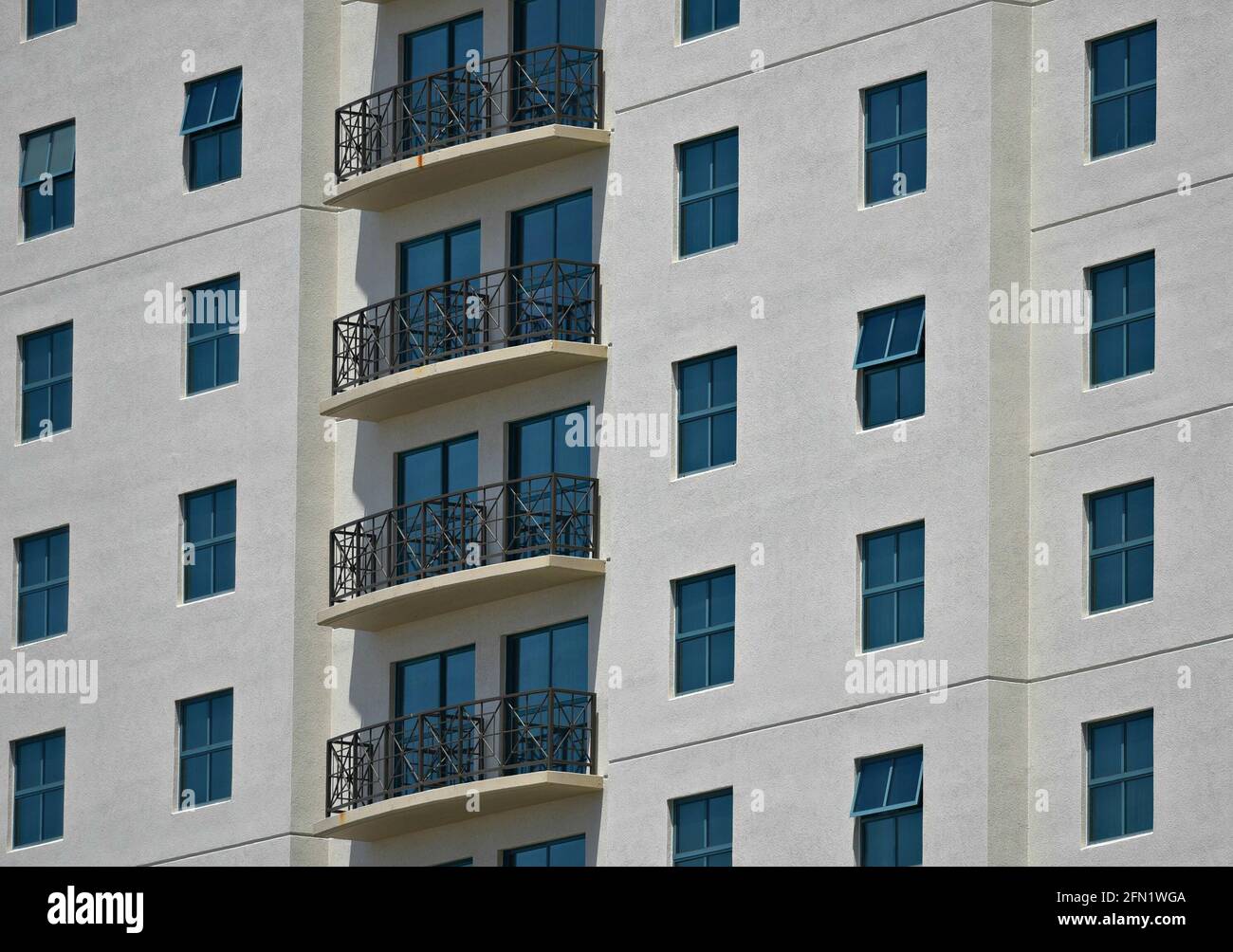 Residential condominiums complex facade with symmetrical windows and ...