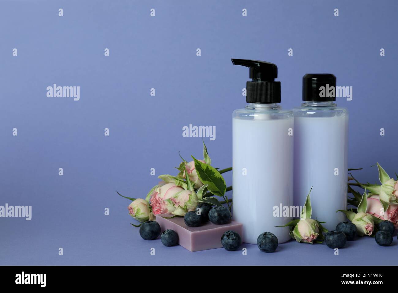 Natural shower gel and ingredients on violet background Stock Photo - Alamy