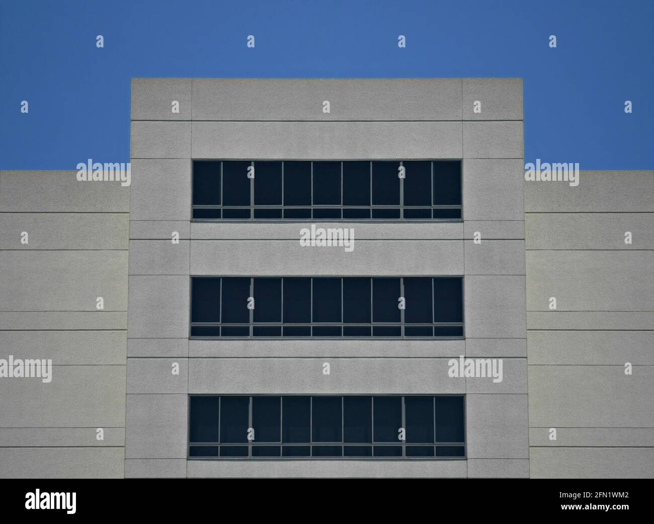 Commercial building symmetrical grey concrete facade in downtown San ...