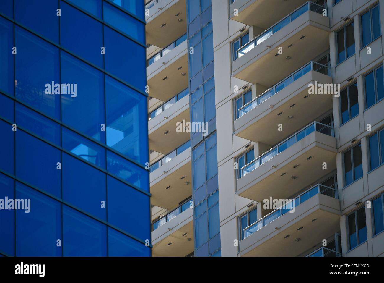 High-rise condominiums complex building facade with symmetrical white ...
