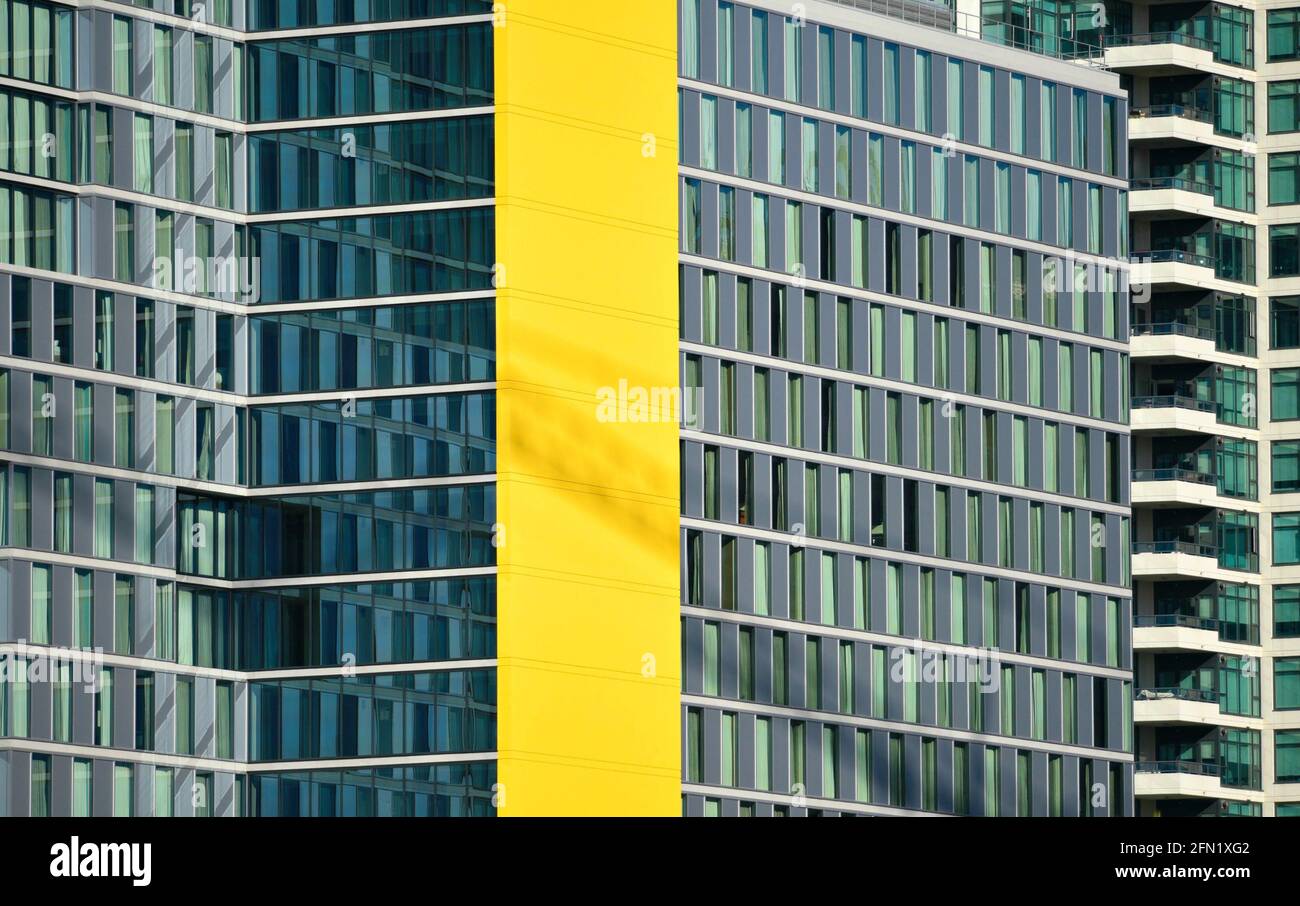 Residential high-rise condominiums complex facade with white and yellow ...