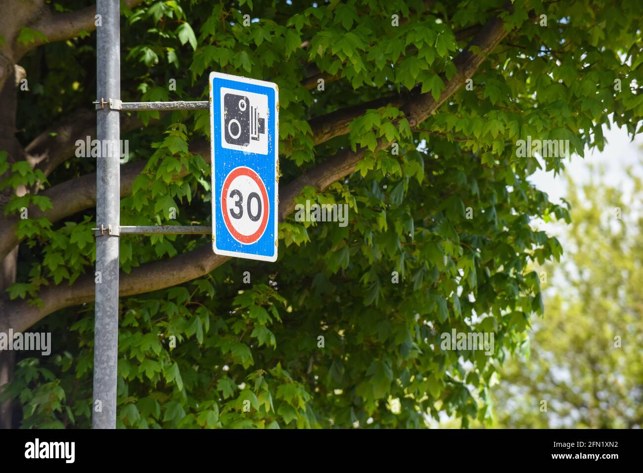 30 mph speed limit warning of traffic camera on city street Stock Photo ...